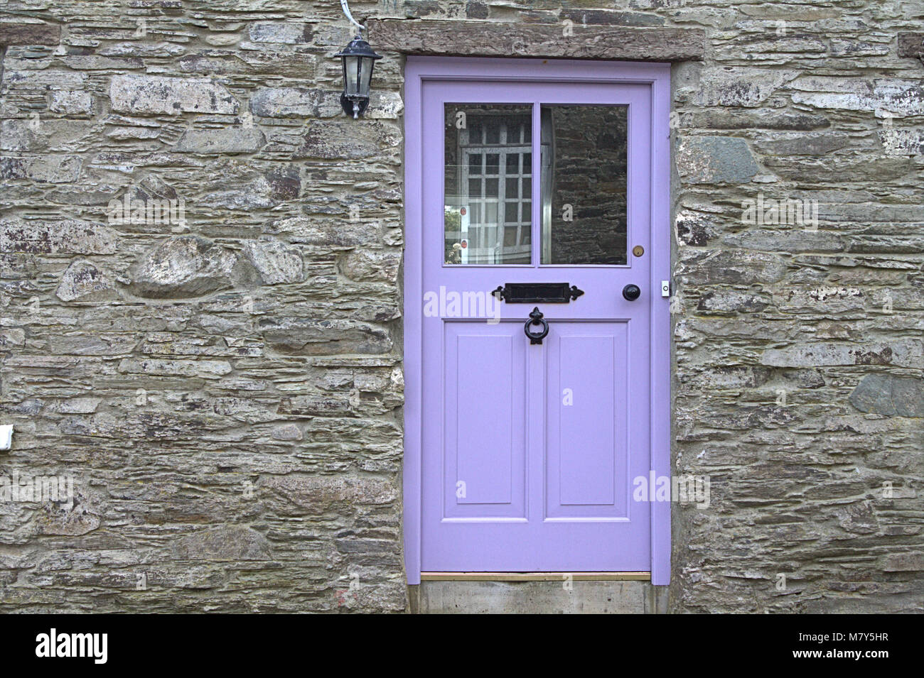 Mauve painted front entrance door to a cottage in ireland Stock Photo ...