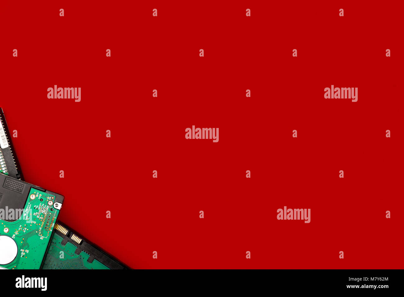 Hard drives in the corner of the frame on the red table with copy space ...
