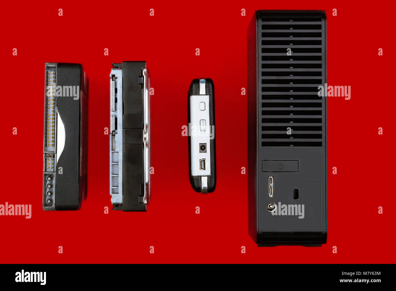 Internal hard drives and external hdd on a red background. Storage ...