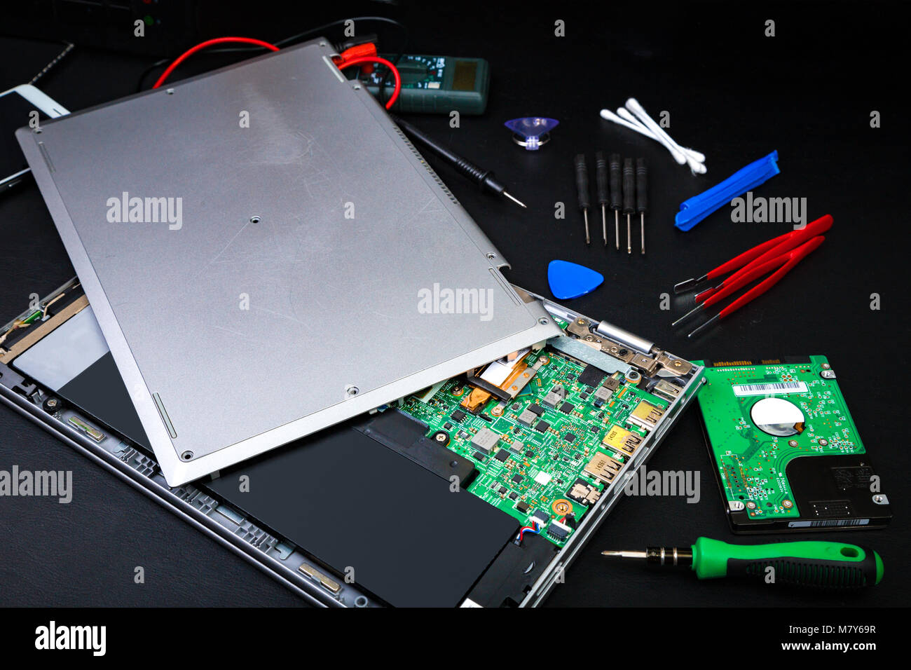 The pieces of laptop with details and special tools for repair on a ...