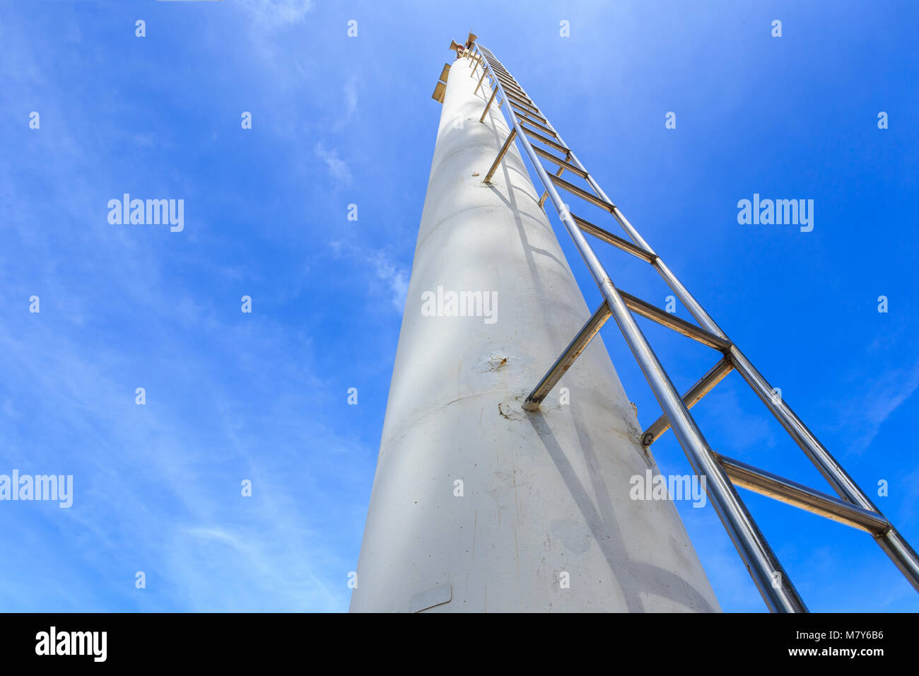 Close up high steel ladder on clear blue sky background Stock Photo - Alamy