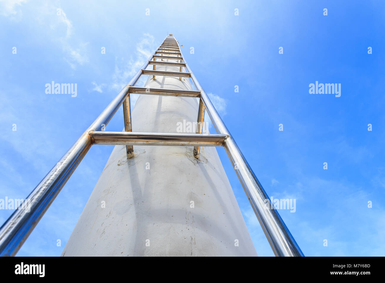 Close up high steel ladder on clear blue sky background Stock Photo - Alamy
