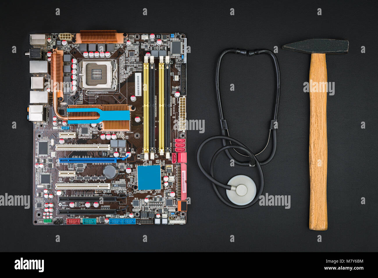 Repair or crash the computer. Broken motherboard, hammer and ...