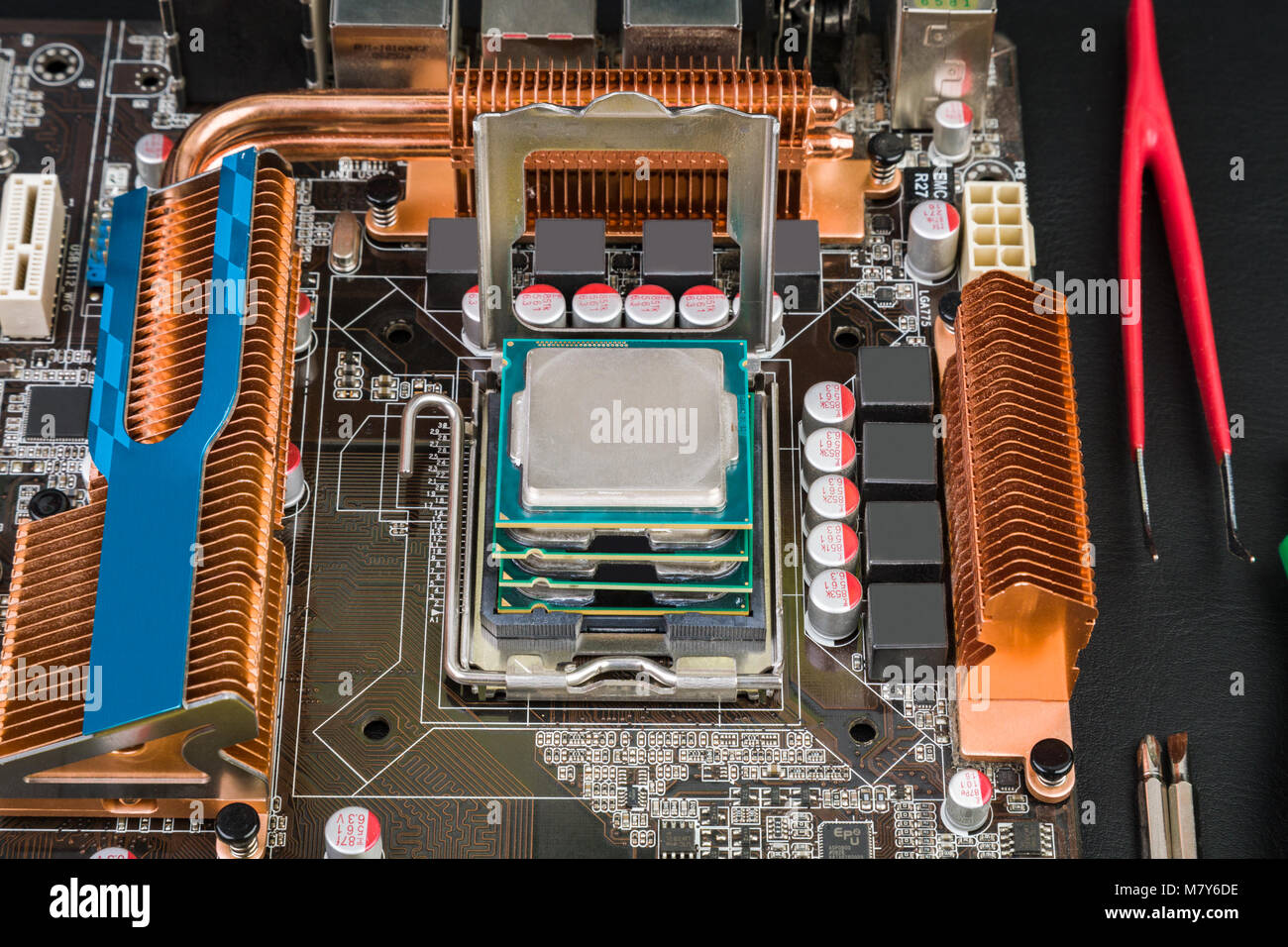 Four processors lie on top of each other in the socket of the ...