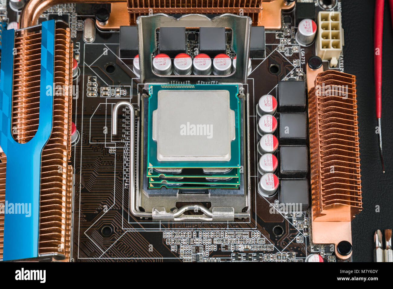 Four processors lie on each other in the game motherboard on a black ...