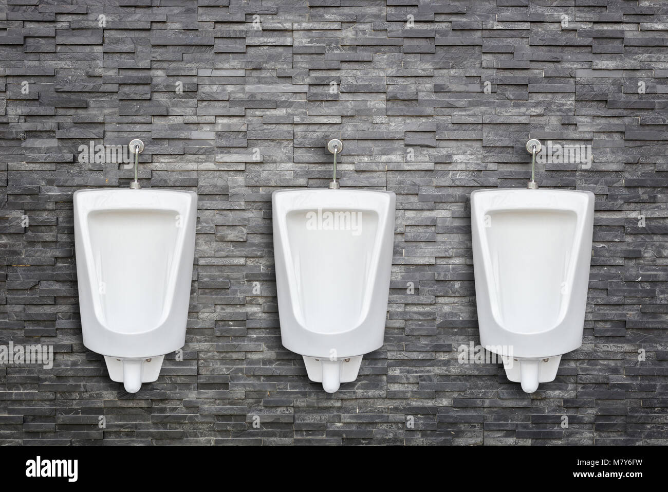 New row of ceramic outdoor urinals in men public toilet install on the ...