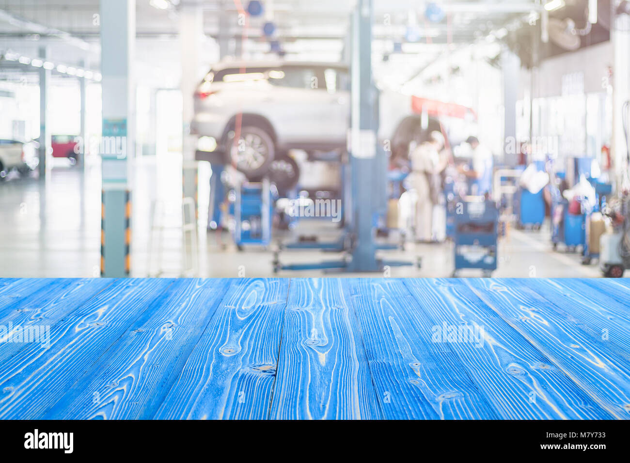 Empty blue wooden table free space and blurred background of car ...