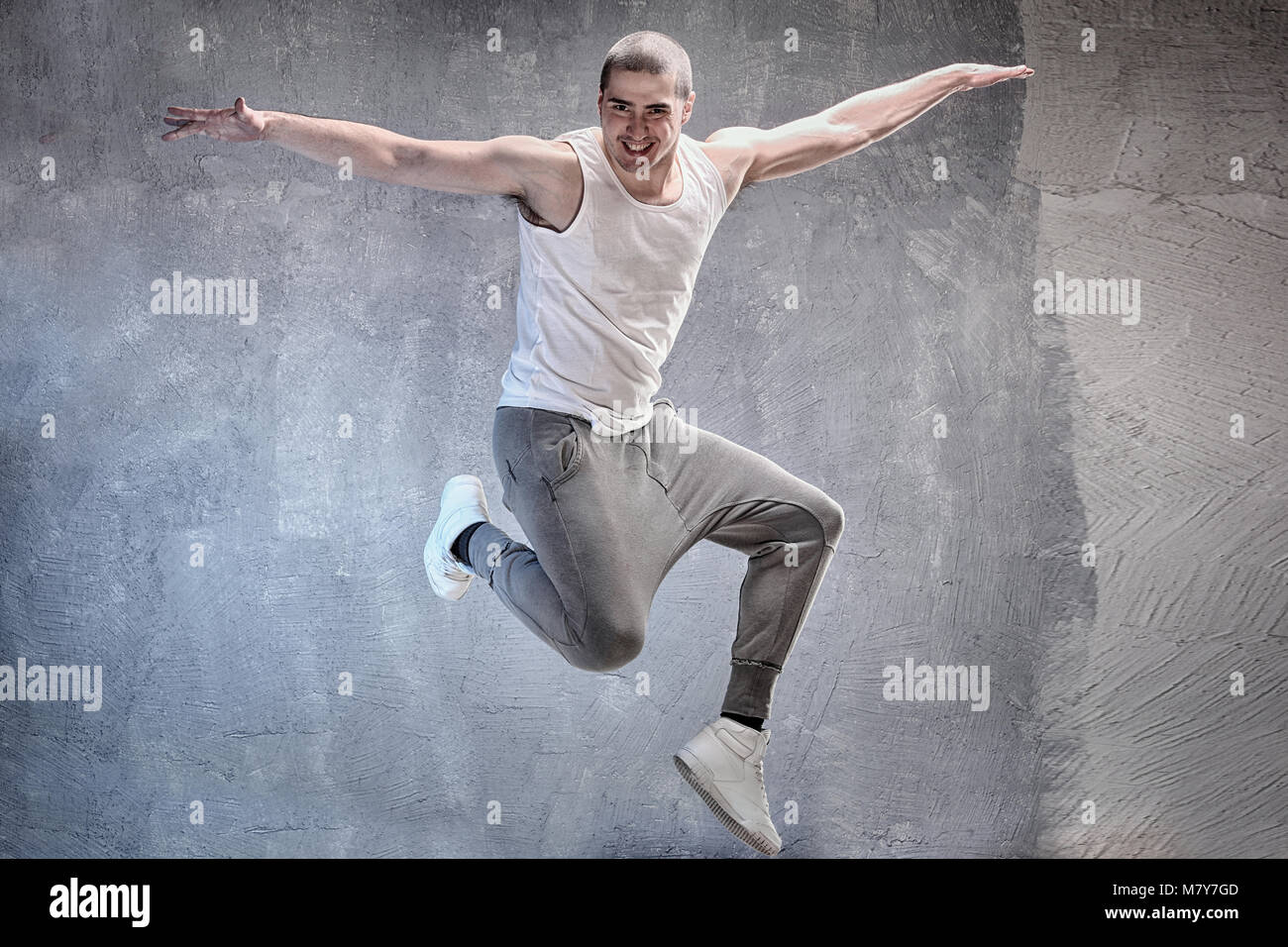 Modern male dancer jumping, smiling Stock Photo - Alamy