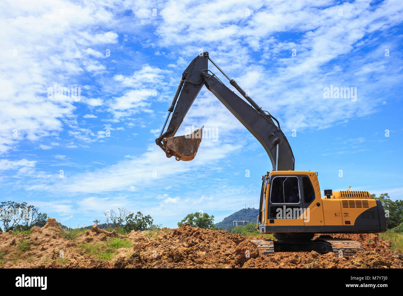 Outdoor work : Excavator digging to moving the soil to the truck and ...