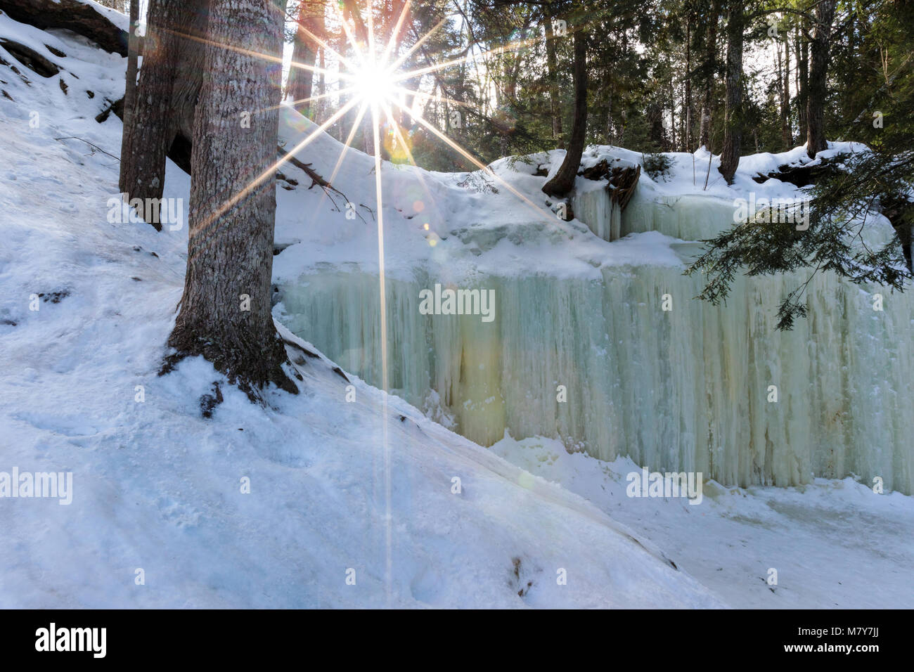 Eben Ice Caves in Michigan's Upper Peninsula spill over a rock ledge ...
