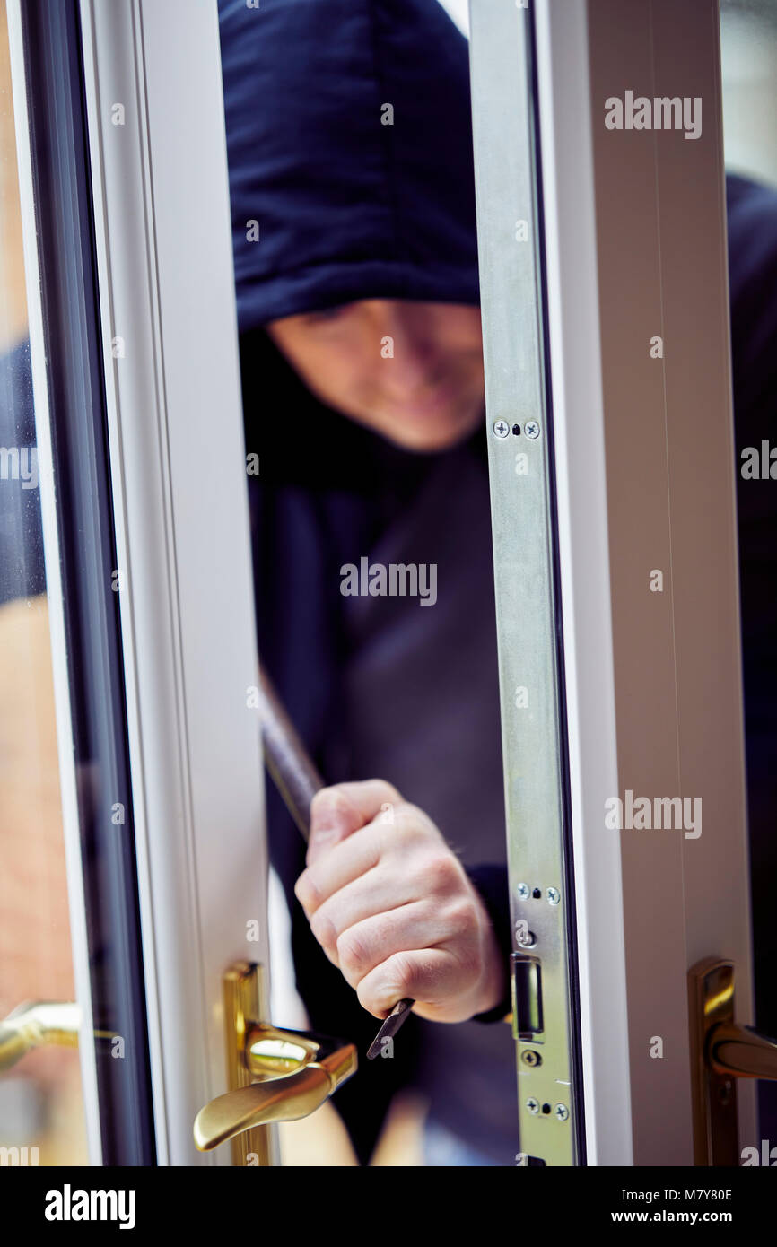 Person breaking into property Stock Photo - Alamy