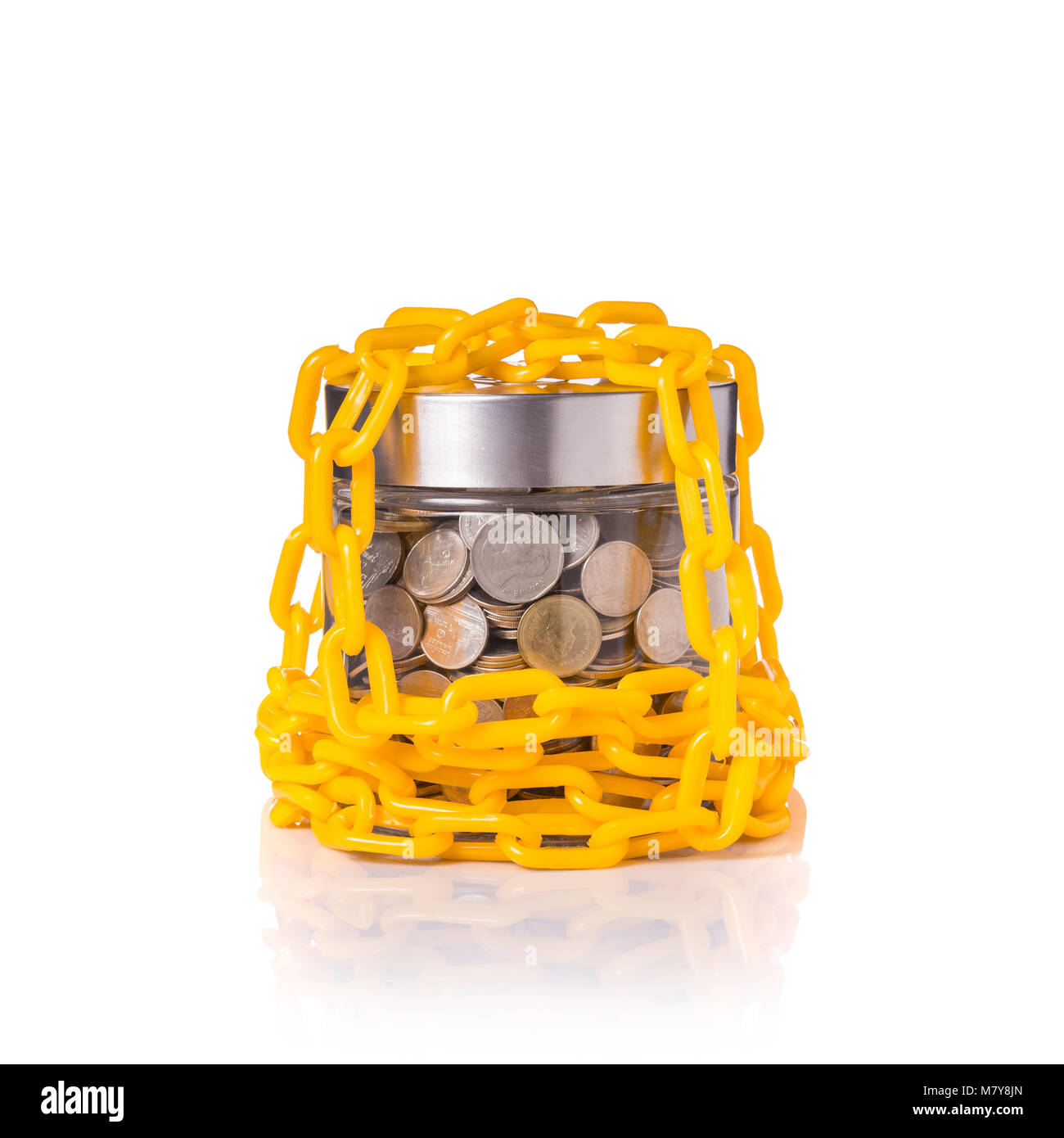 Yellow chain lock around clear glass jar of Thai coin (baht). Studio ...