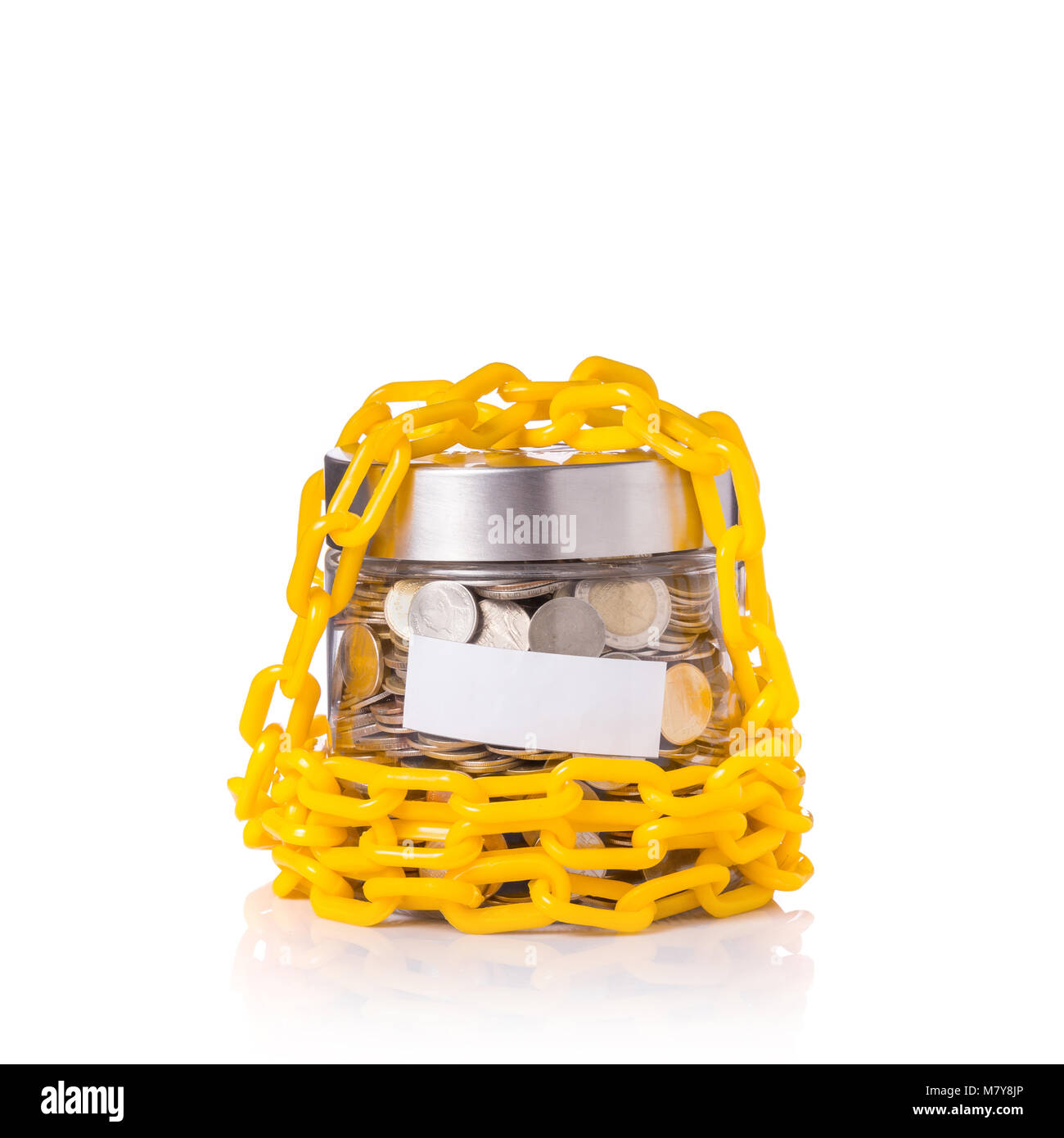 Yellow chain lock around clear glass jar of Thai coin (baht). Studio ...