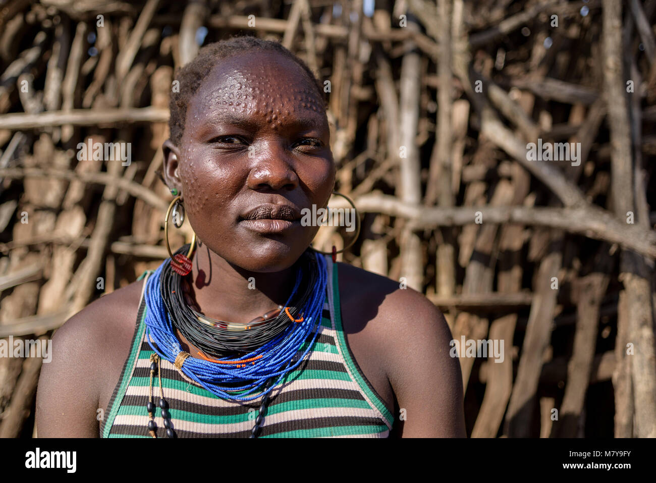 Portrait of a young Karamajong woman with traditional scars on her face ...