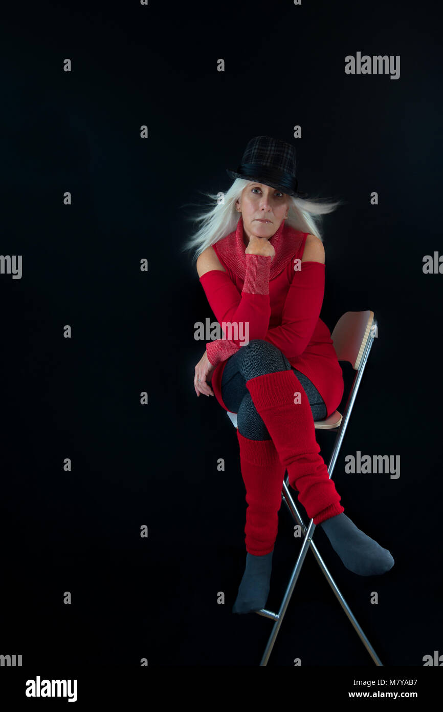 Photographer's self-portrait in a minimalist style pose sitting in tall ...