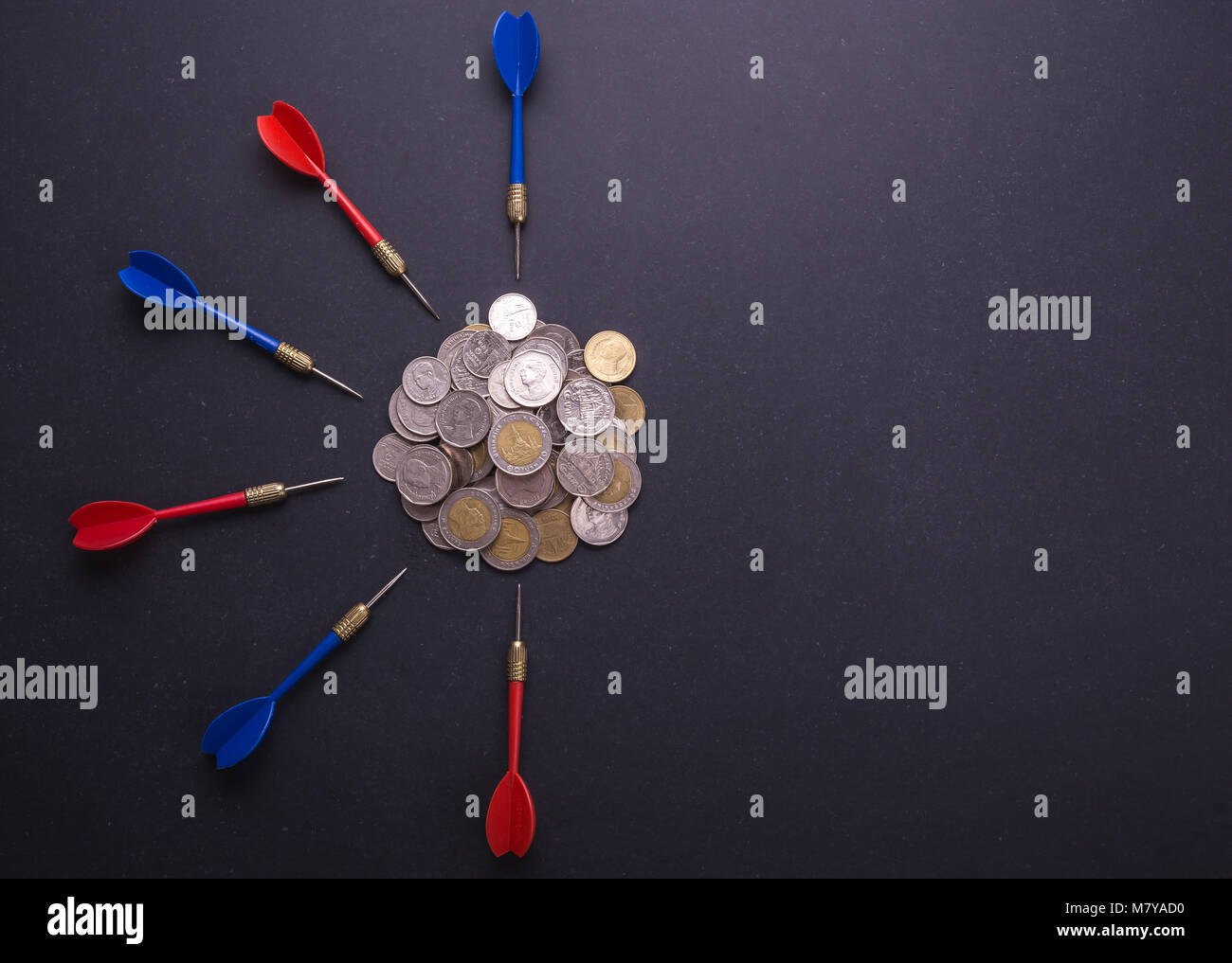 Money or finance target concept. Red and blue darts and coin on black ...