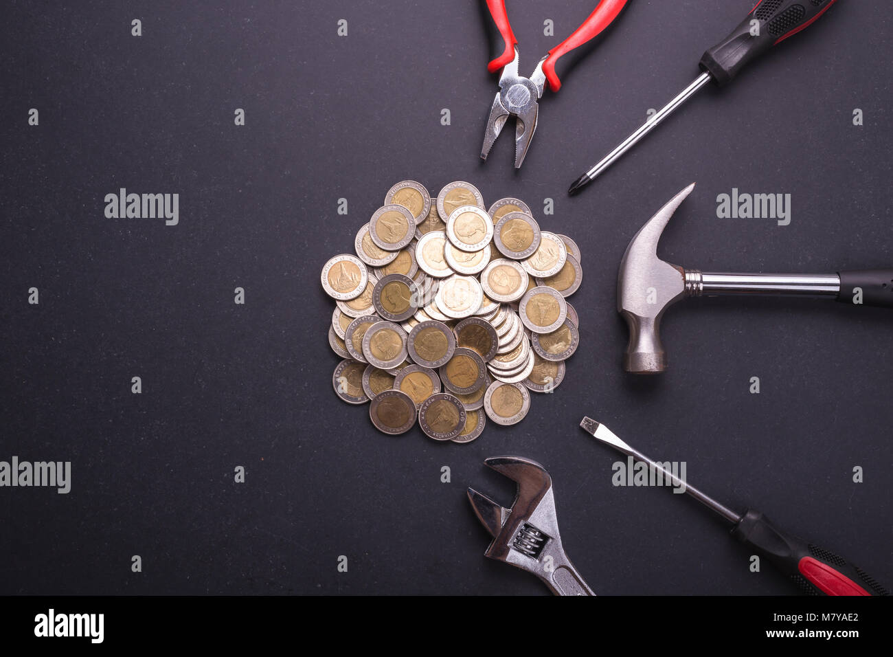 Repair or fixing money or financial concept. Industrial tool and pile ...