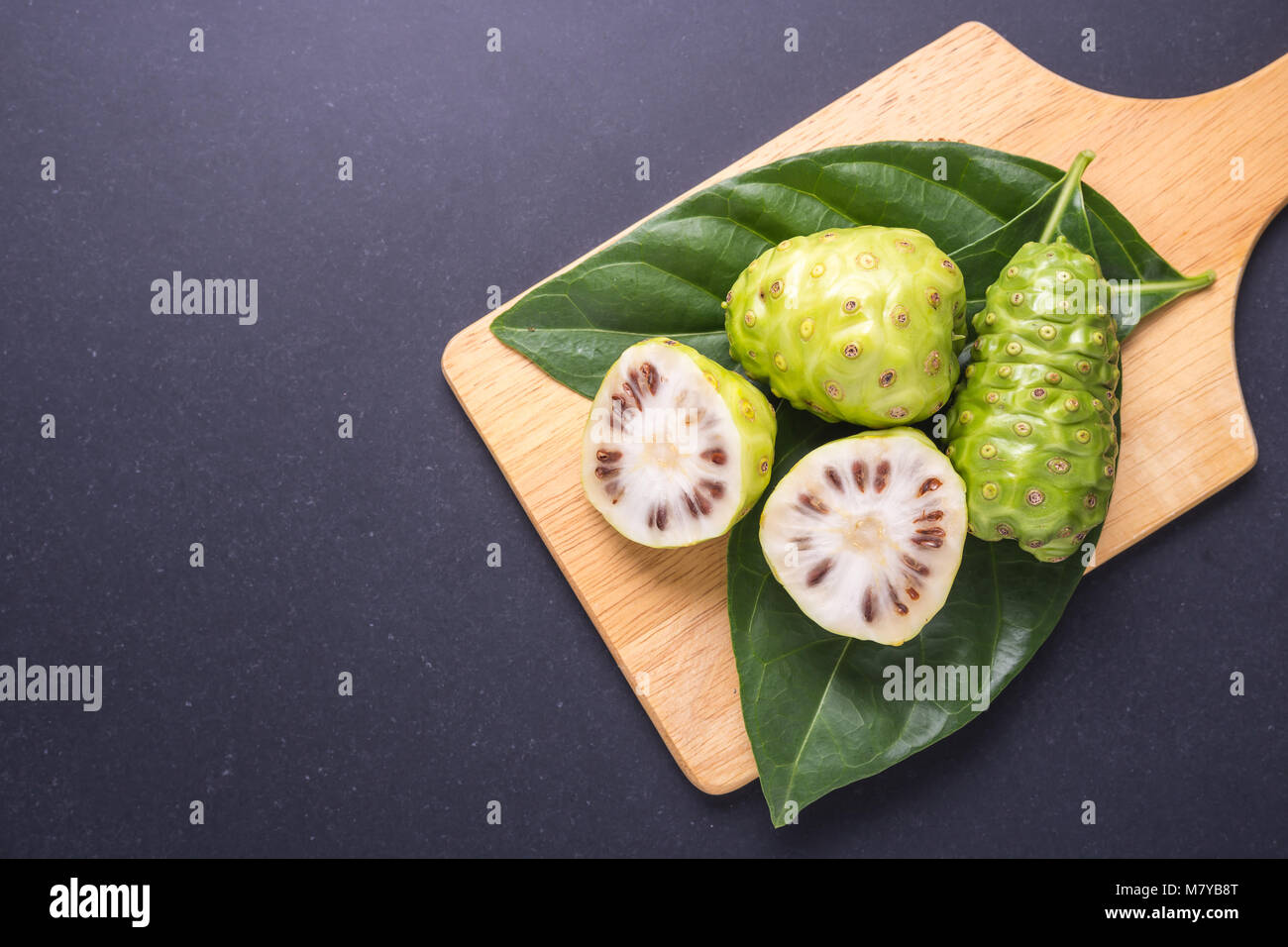 Fruit of Great morinda (Noni) or Morinda citrifolia tree and green leaf ...