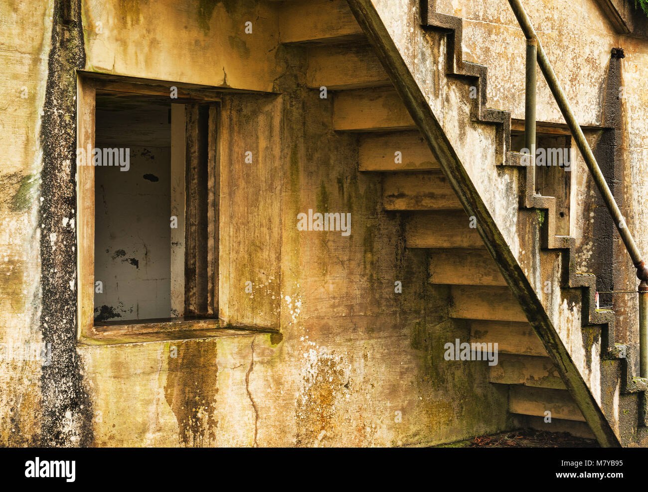 Close up section of an exterior wall of an old bunker with a window and ...