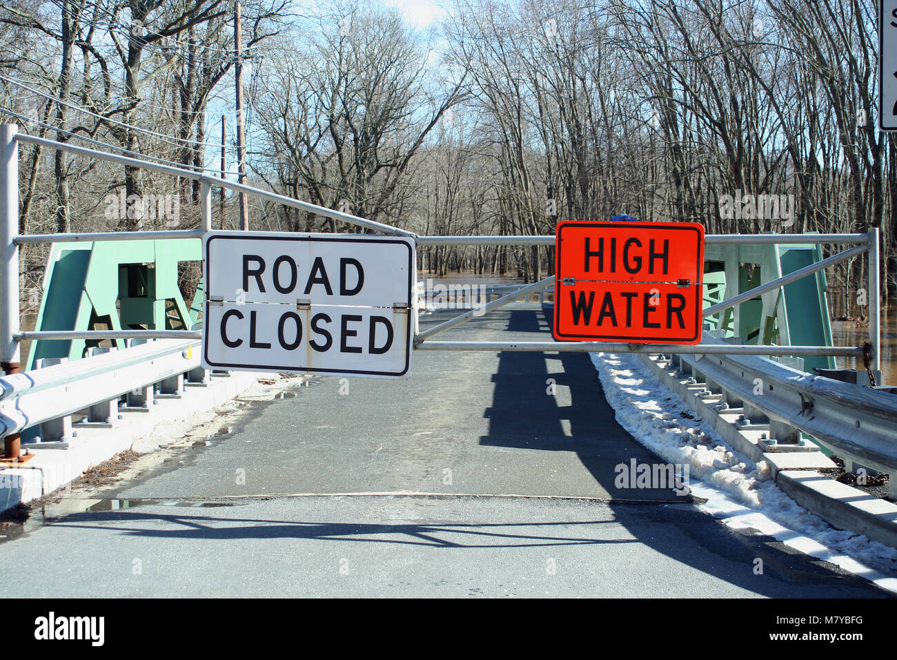 A Flooded road closed sign on a bridge Stock Photo - Alamy
