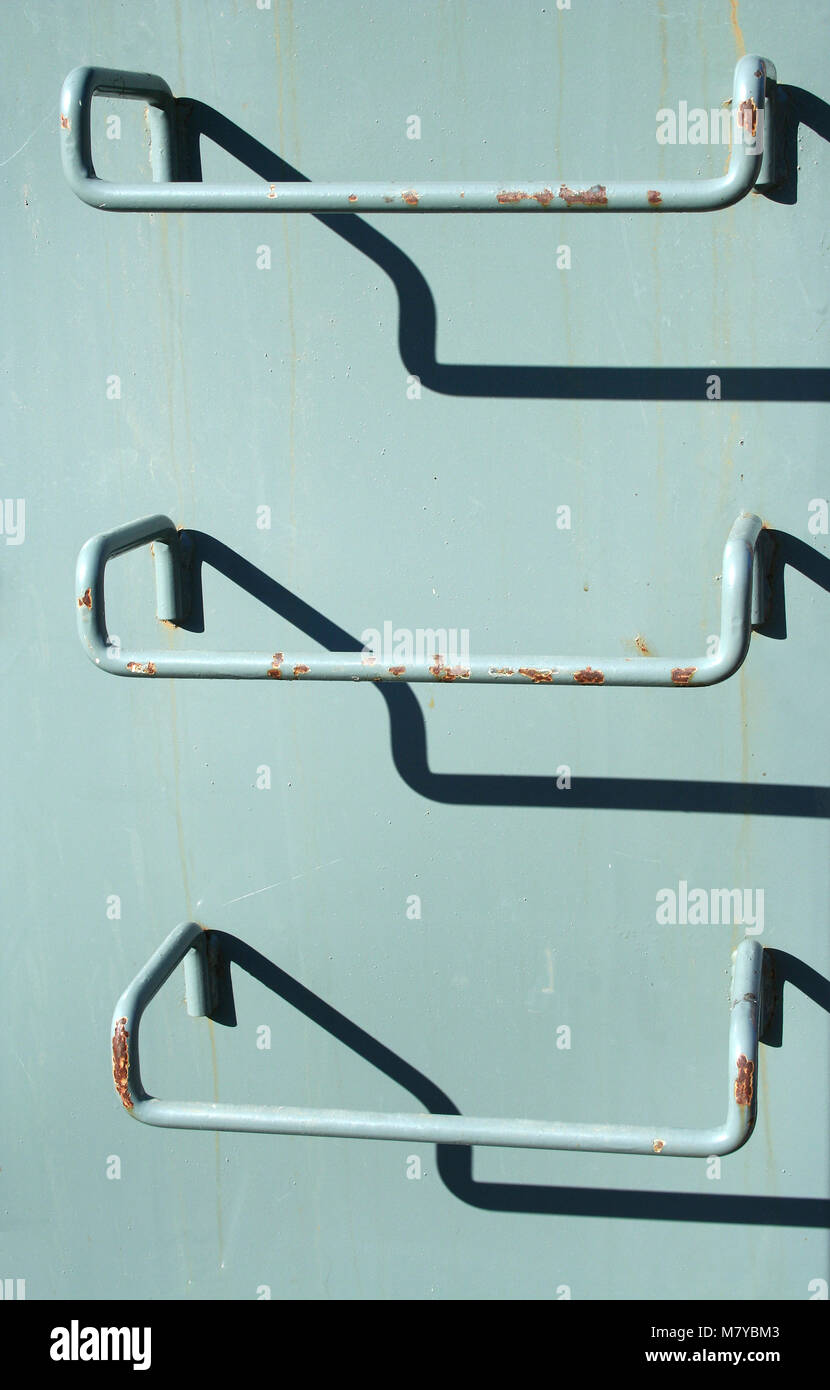 A Green dumpster ladder with shadow Stock Photo - Alamy