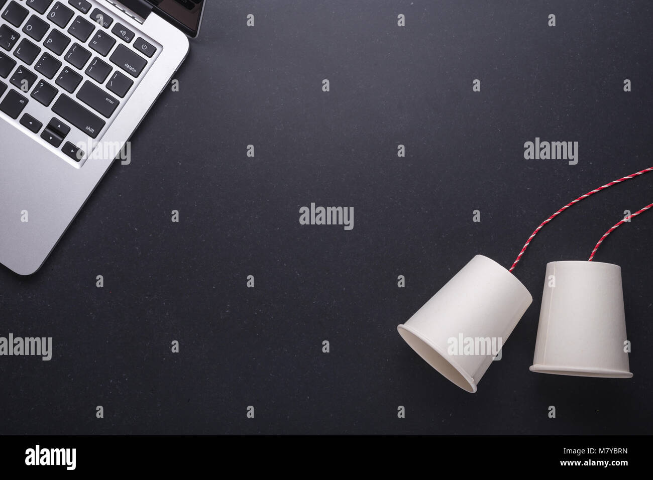 Two white paper cup connect with red rope used for classic phone and ...