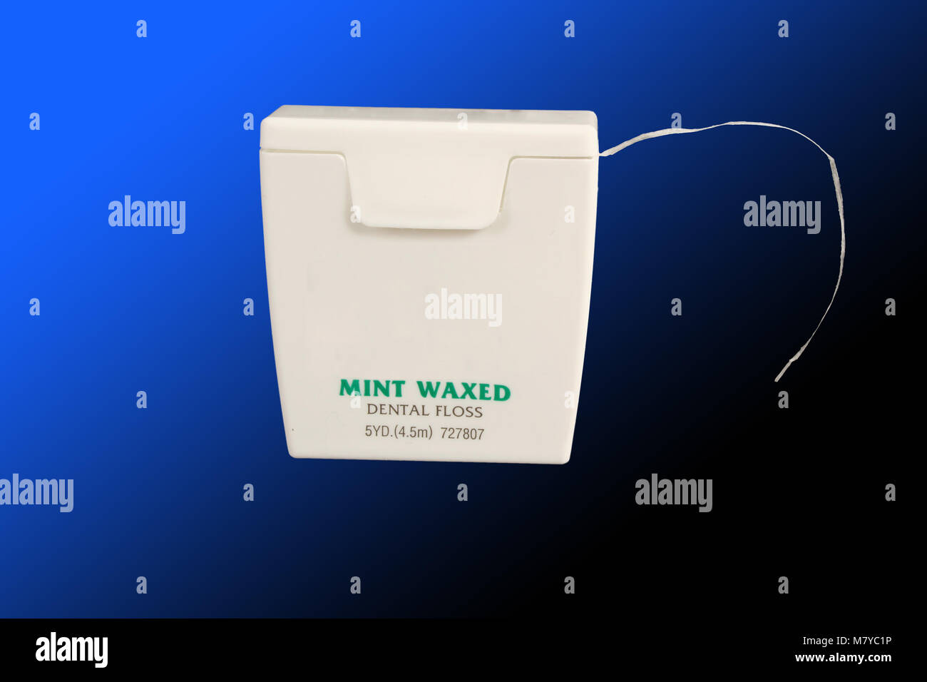 Dental floss on blue and black background Stock Photo - Alamy