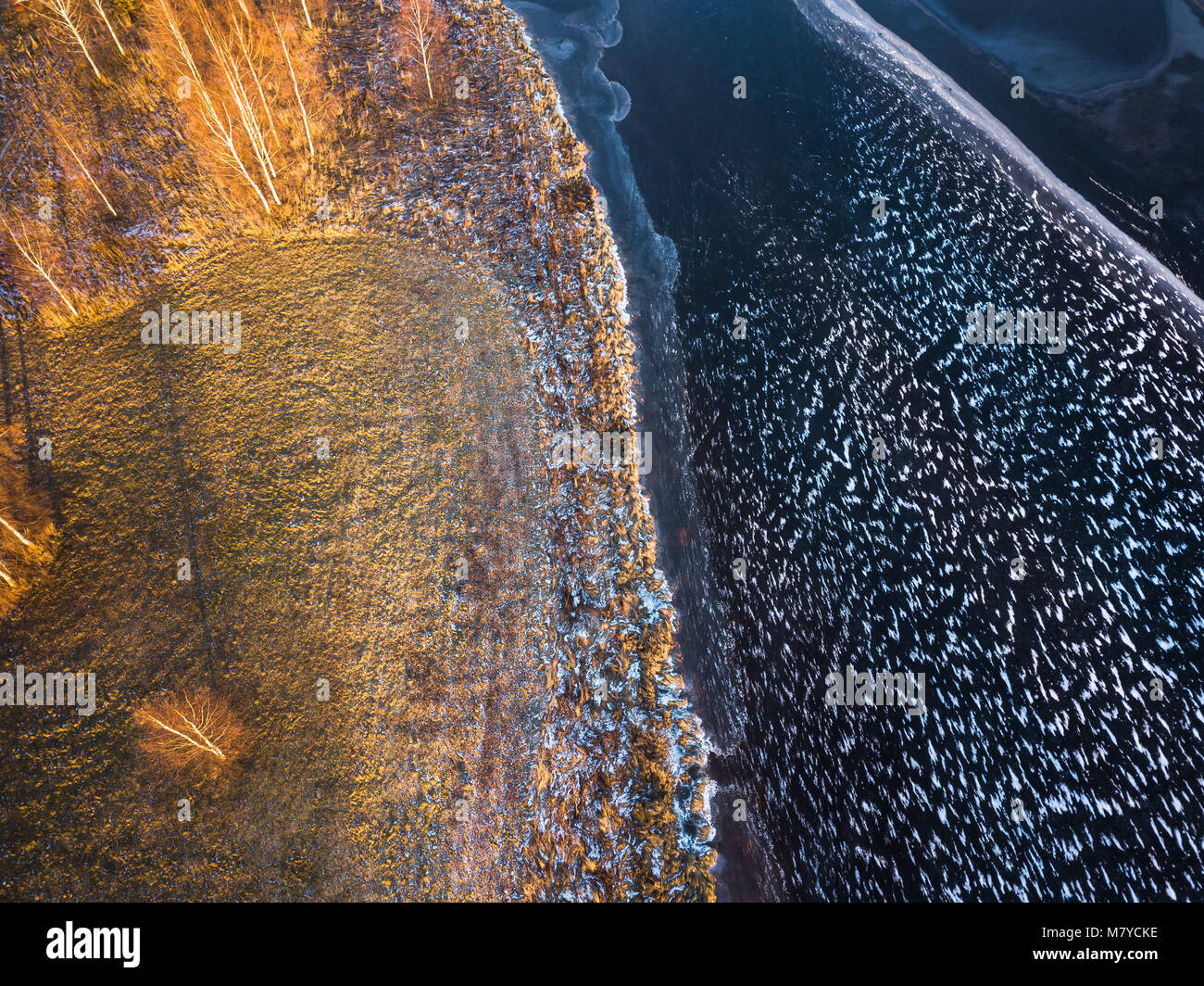 Aerial Drone Photograph of a Partly Frozen Lake Surrounded with ...