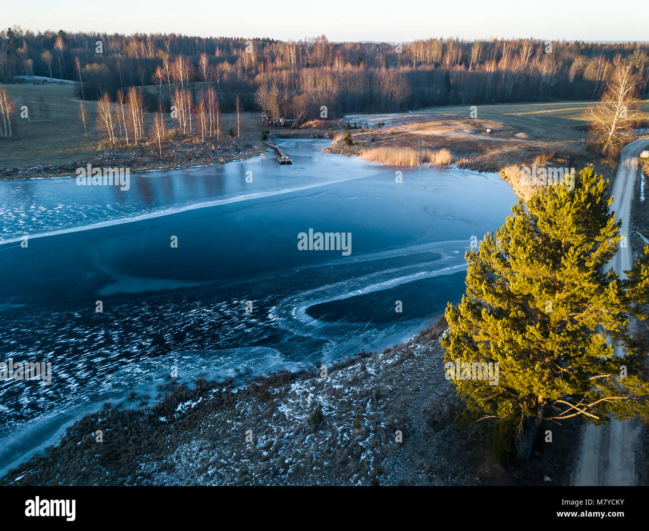 Aerial Drone Photograph of a Partly Frozen Lake Surrounded with ...