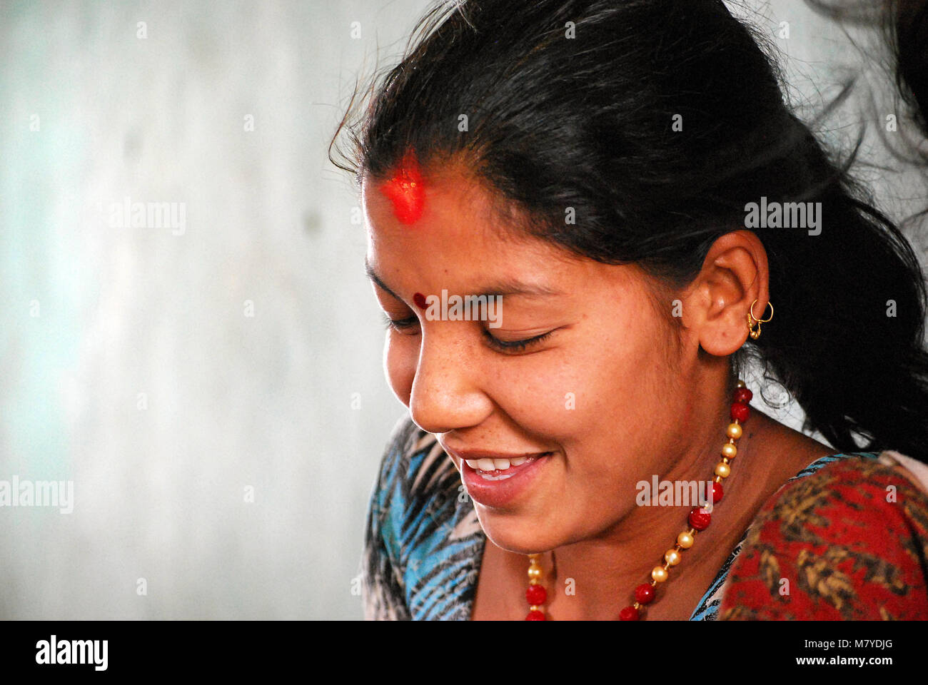 Portrait of a young woman. The red mark on the forehead means that she ...