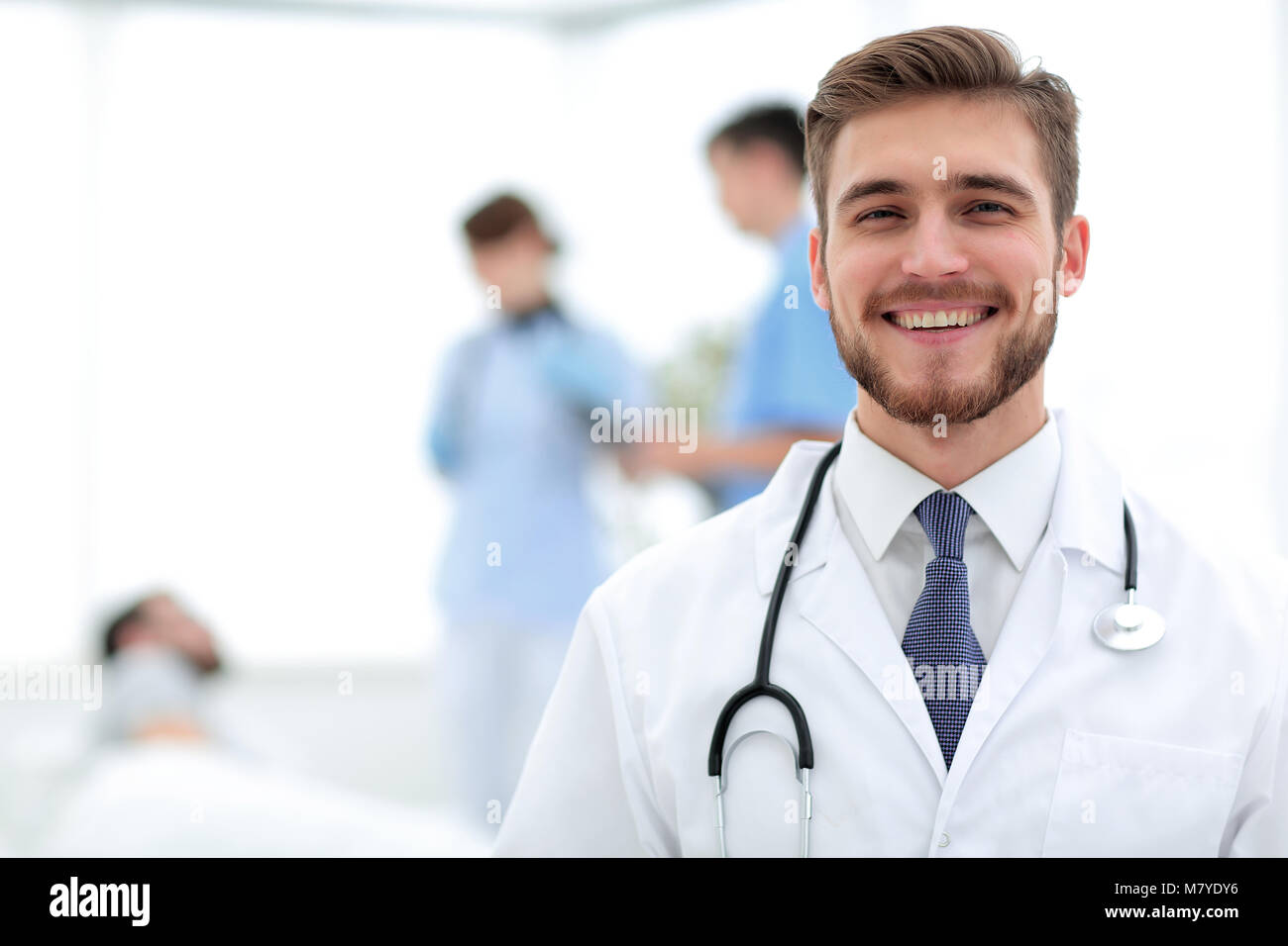 smiling doctor on blurred background Stock Photo - Alamy