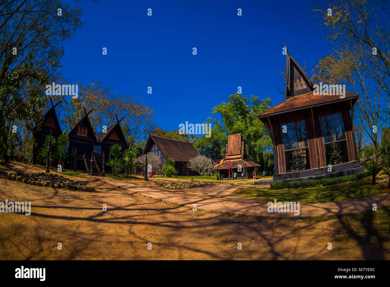 Outdoor view of many houses in Baan Dam museum, the Black House in ...