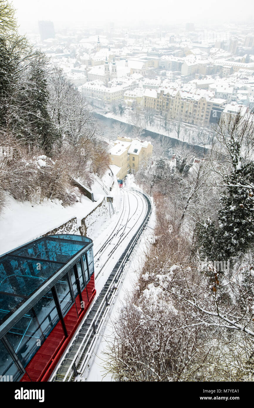 Red funicular railway cable car on hill Schlossberg with aerial view to ...