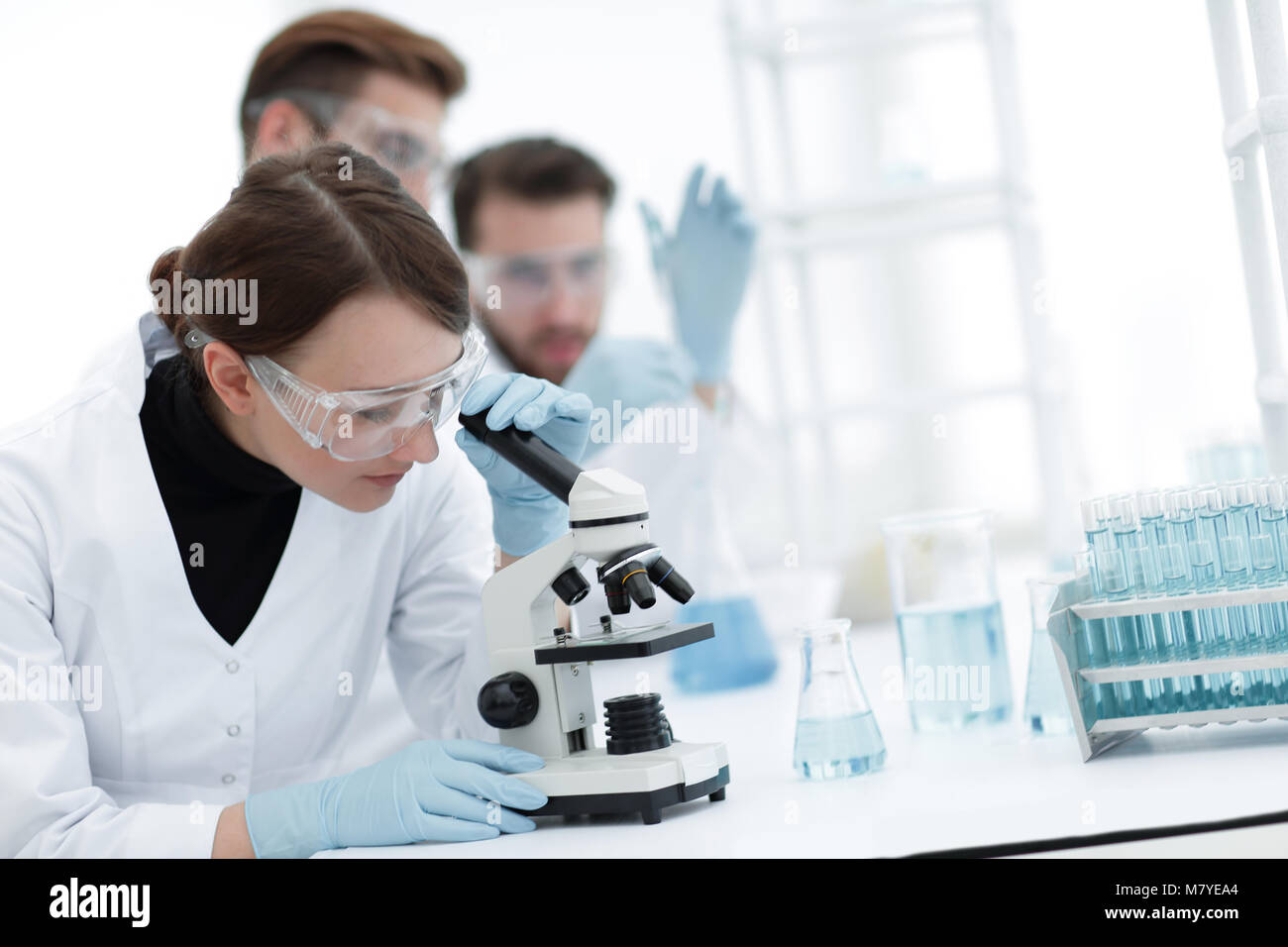 female scientists looking into a microscope Stock Photo - Alamy