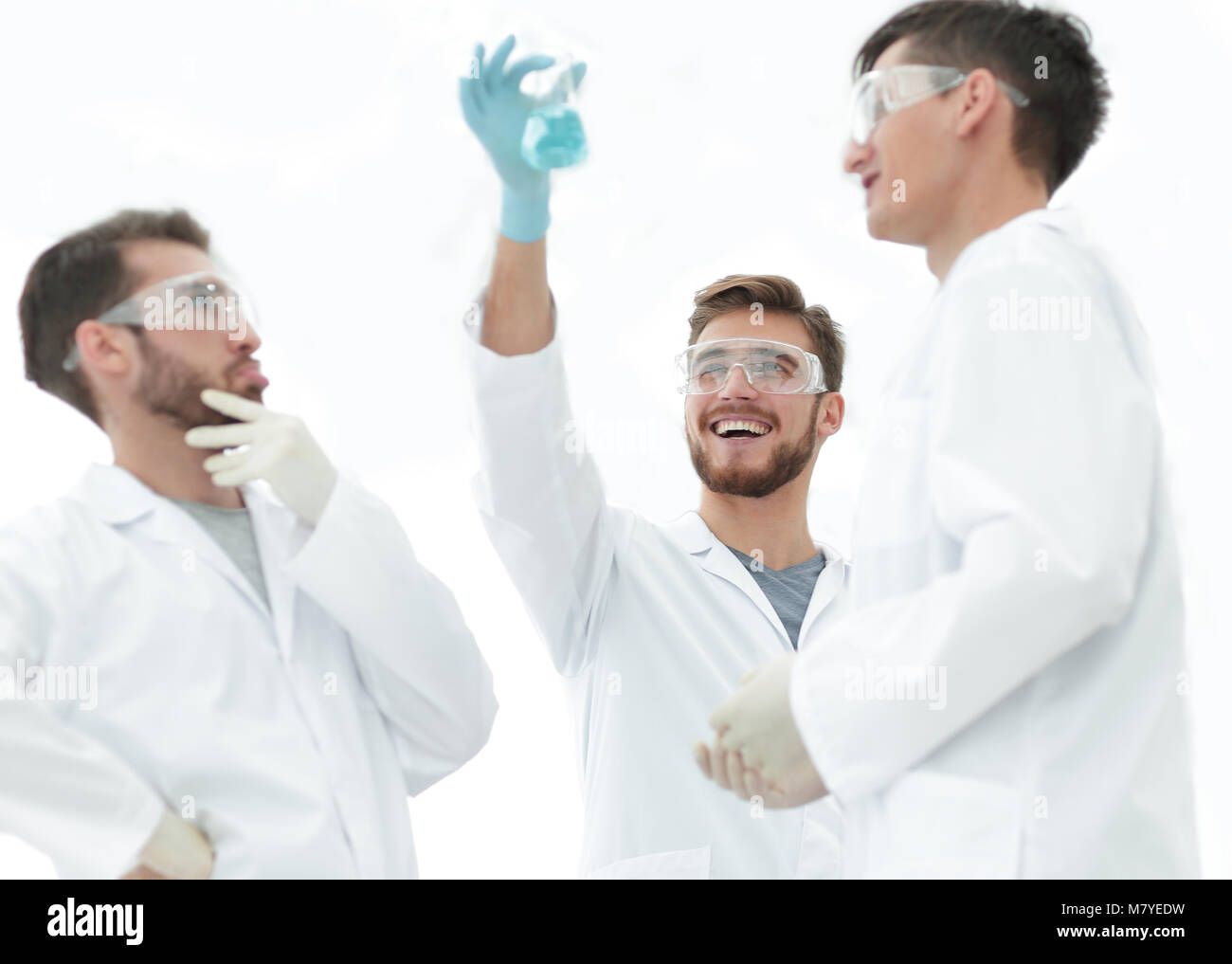 scientists studying the liquid in the beaker Stock Photo - Alamy