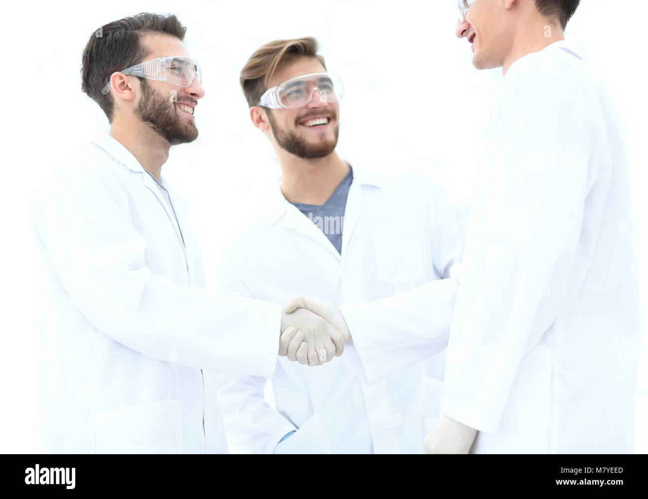 blurred image of a handshake between scientists Stock Photo - Alamy
