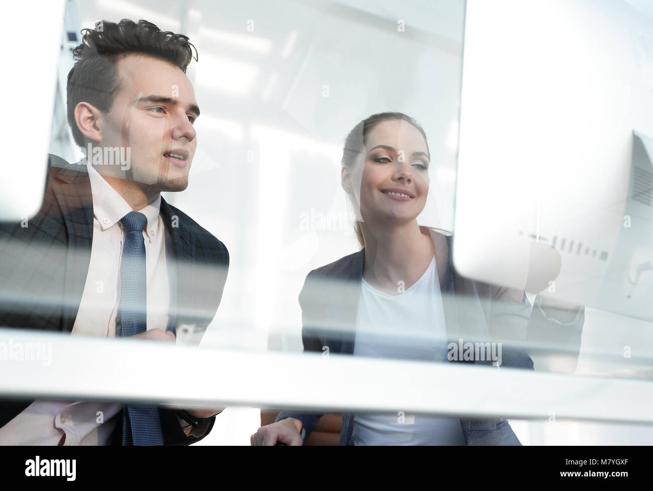 from behind the glass. colleagues at the workplace Stock Photo - Alamy