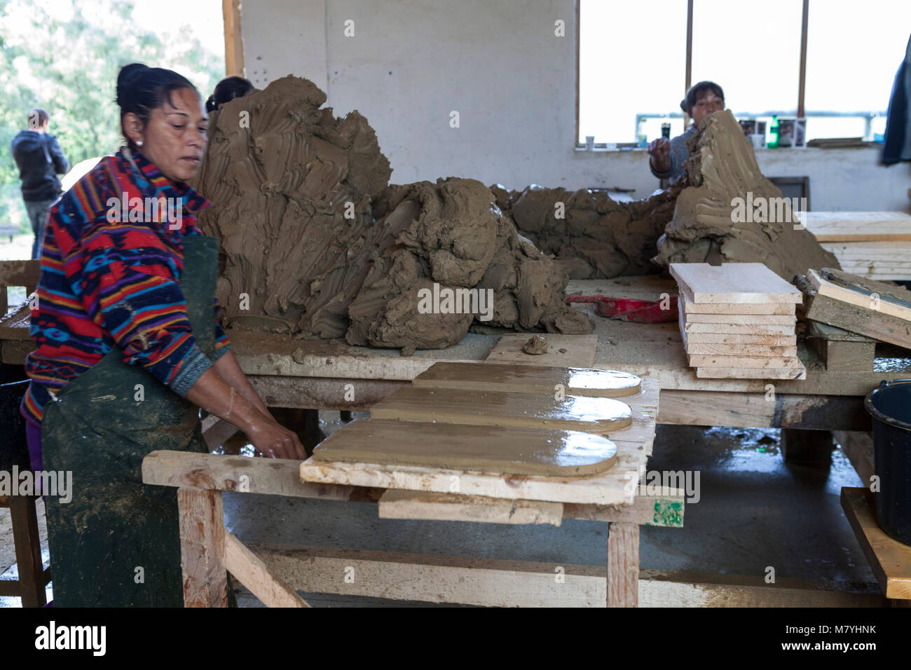 People making roof tiles from clay using traditional methods in ...