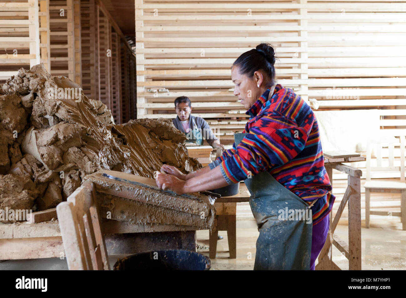 People making roof tiles from clay using traditional methods in ...