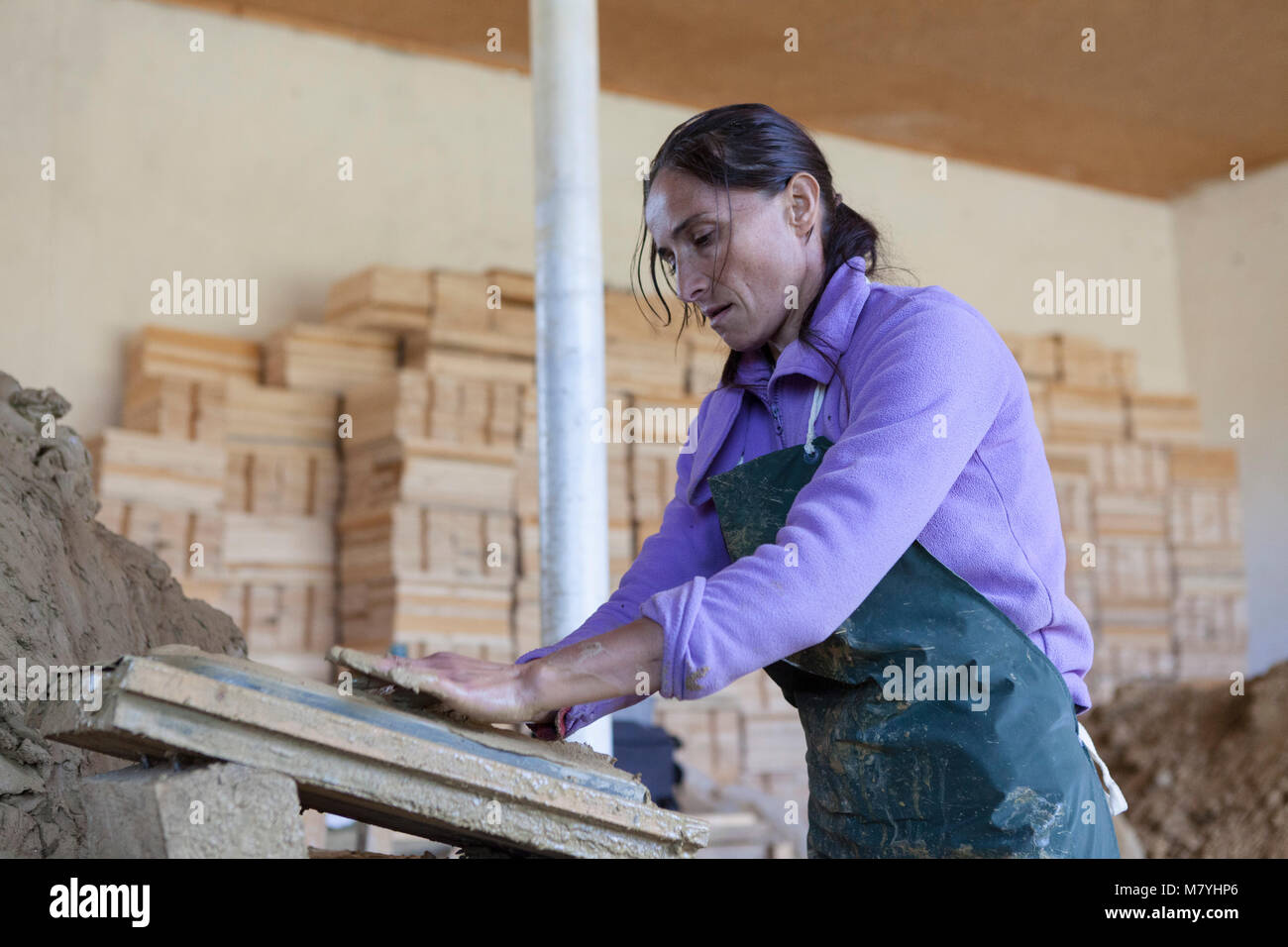 People making roof tiles from clay using traditional methods in ...
