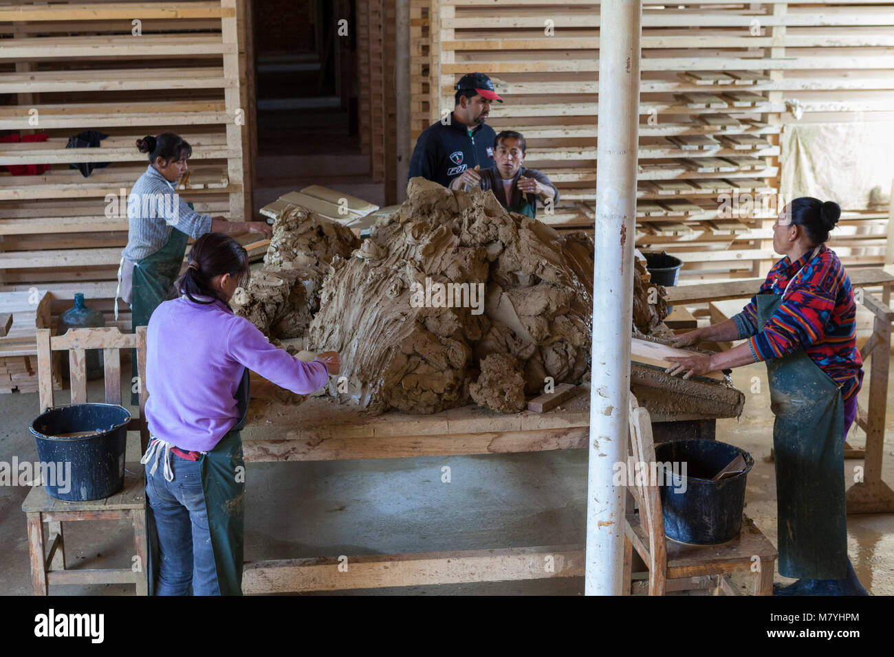 People making roof tiles from clay using traditional methods in ...
