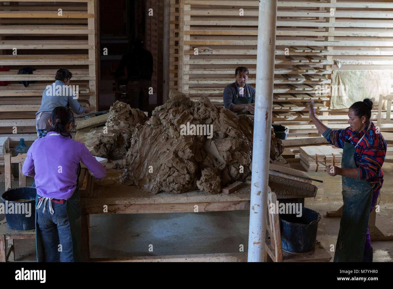 People making roof tiles from clay using traditional methods in ...