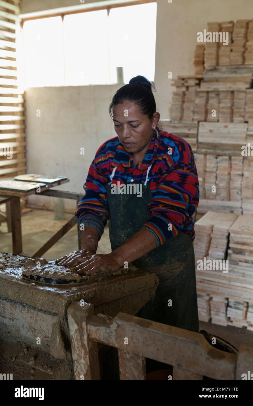 People making roof tiles from clay using traditional methods in ...
