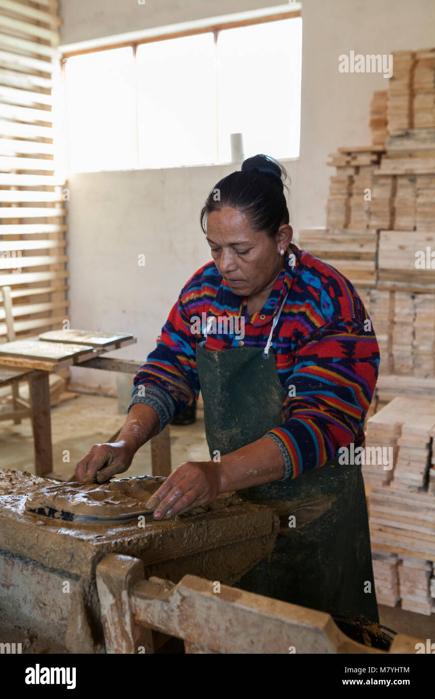 People making roof tiles from clay using traditional methods in ...