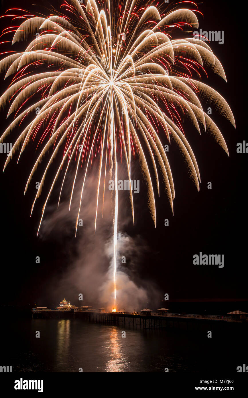 Fireworks bursting over Llandudno pier on the North Wales coast Stock ...
