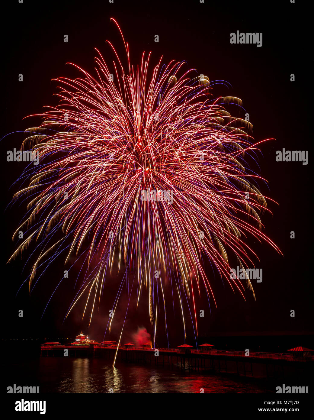 Fireworks bursting over Llandudno pier on the North Wales coast Stock ...