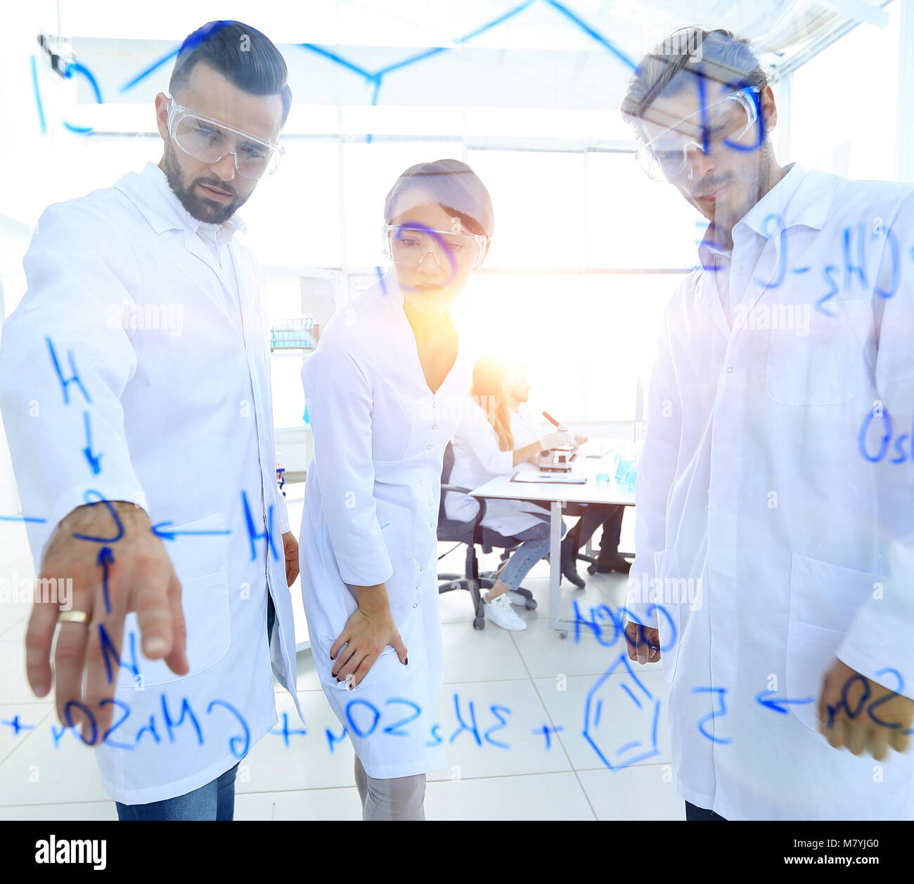 group of laboratory scientists discussing their research in the Stock ...