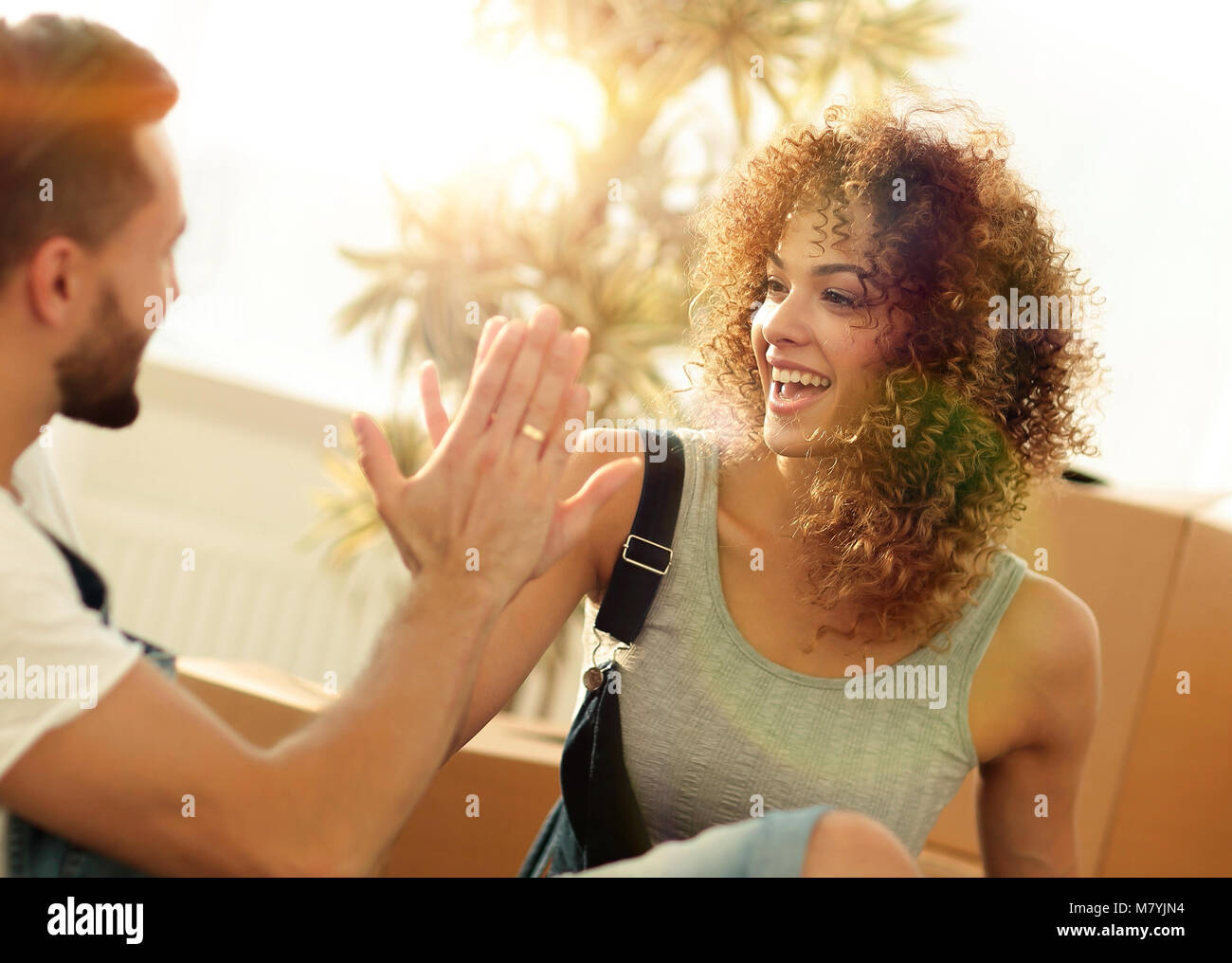 young couple giving each other five with a new home Stock Photo - Alamy