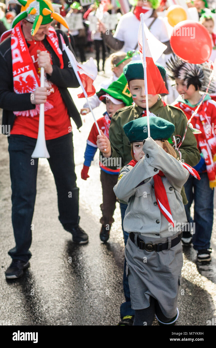 A small Polish scouting girl marches and holds the Polish flag during ...