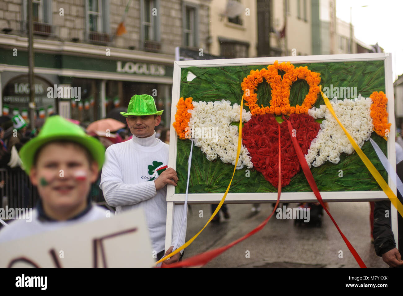 Members of the Irish Polish community holding the symbol of Irish ...
